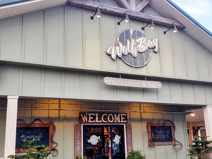 The understated elegance of Wolf Bay's wooden sign hints at what awaits inside&mdash;seafood that doesn't need to shout to get your attention.