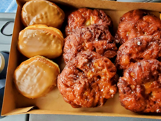 The maple bars and apple fritters nestled in this box aren't just donuts—they're ambassadors of joy heading to their diplomatic mission at your breakfast table.