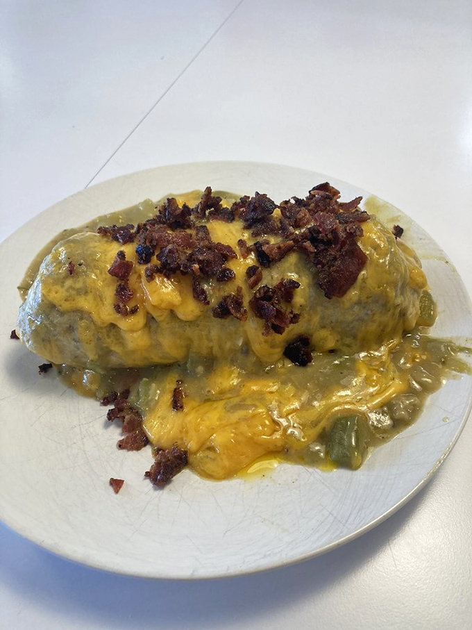 Behold: the burrito that launched a thousand road trips. Crispy bacon bits and melted cheese create a symphony of breakfast bliss.