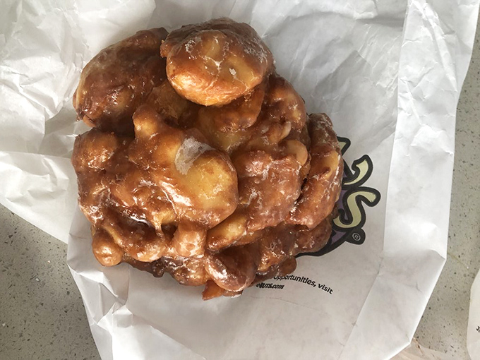This isn't just an apple fritter—it's an edible work of art that somehow transforms fruit into the world's most perfect breakfast delivery system.