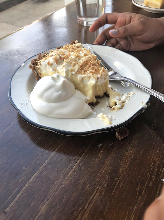The coconut cream pie mid-demolition tells the real story&mdash;resistance is futile when faced with layers of creamy filling and toasted coconut shards.
