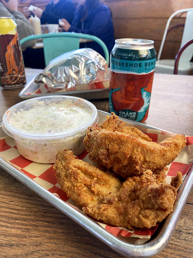 A tray of crispy tenders with coleslaw – proof that happiness doesn't need to be complicated, just perfectly seasoned.