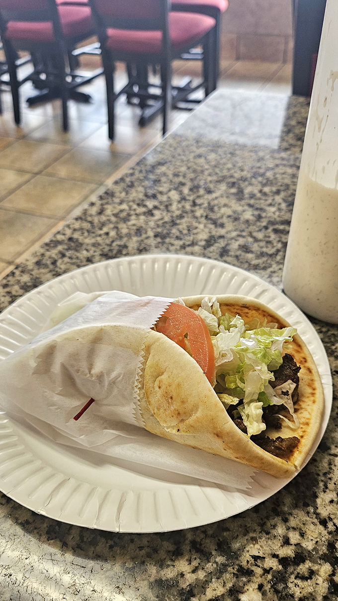 Not all heroes wear capes; some come wrapped in pita. This open-faced beauty reveals its treasures like a Mediterranean sunset.