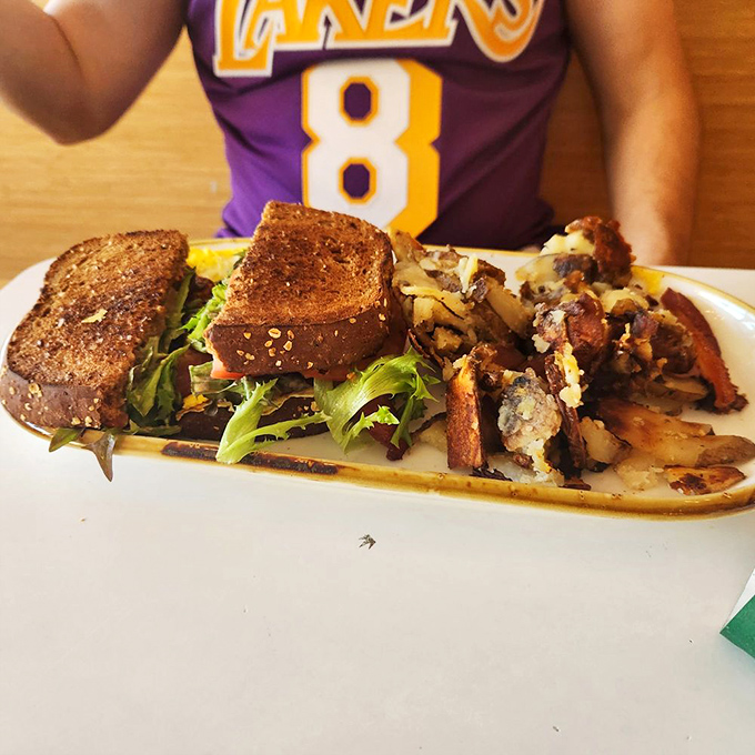 This sandwich isn't just lunch&mdash;it's edible architecture where toast, greens, and golden potatoes create a delicious skyline of flavor.