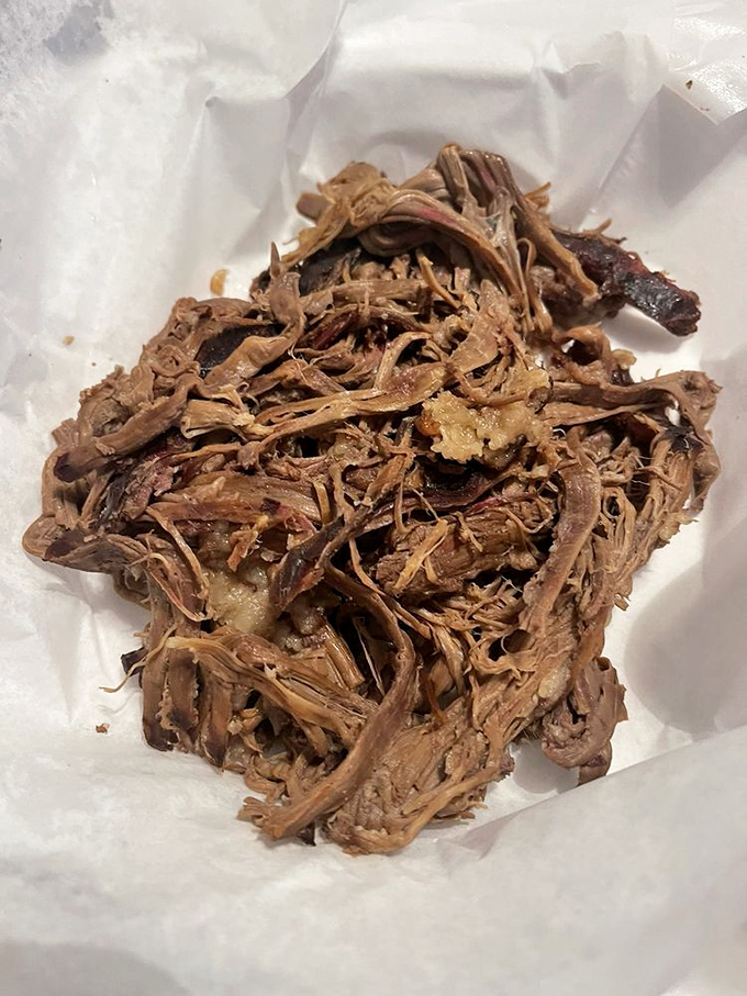 Behold: pulled brisket in its natural habitat. Those tender strands have earned their rest after a 14-hour smoke marathon.