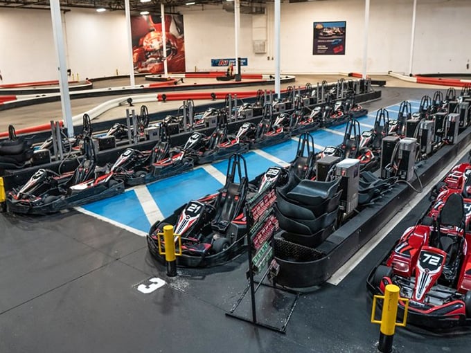 Electric chariots awaiting their gladiators. The modern colosseum smells of rubber and adrenaline instead of lions.