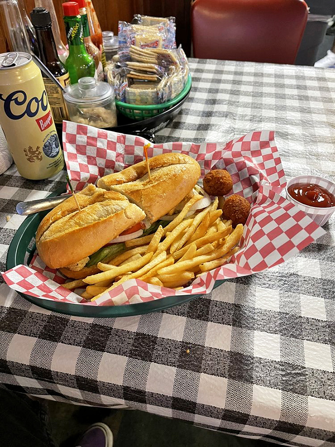 The checkered paper cradles seafood perfection. Those hushpuppies aren't just sides&mdash;they're supporting actors deserving their own Oscar category.