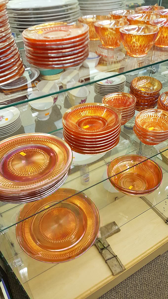 Amber glassware that glows like liquid sunshine. These Depression-era dishes have survived longer than most Hollywood marriages.