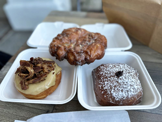 Three perfect specimens on display. That apple fritter looks like it could win a beauty pageant for fried dough.