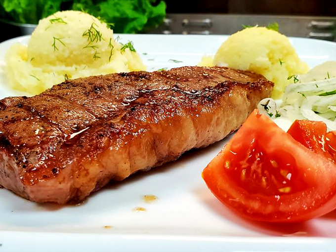 This isn't just a steak; it's a work of art with grill marks that deserve their own museum. The simple presentation lets quality speak volumes.