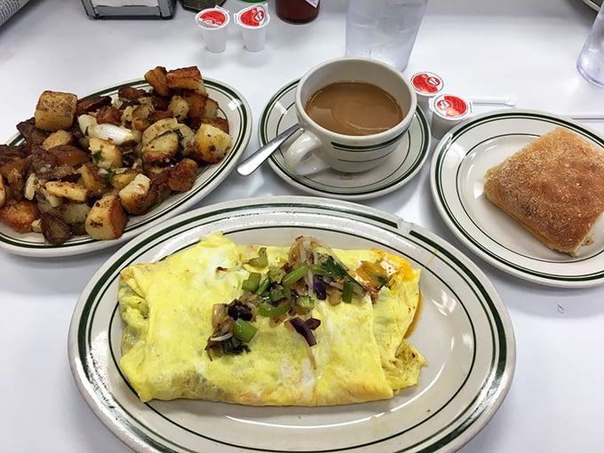 The perfect breakfast trinity: a fluffy omelet, golden hash browns, and coffee strong enough to resurrect the dead.