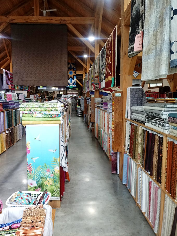 A fabric hunter's paradise where aisles become adventures, with quilted treasures hanging above like textile constellations guiding your journey.
