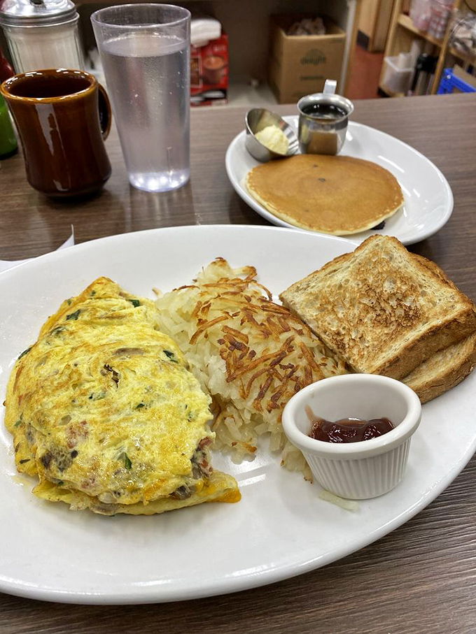 This isn't just an omelette – it's a masterclass in egg architecture with a supporting cast of perfectly sautéed vegetables.