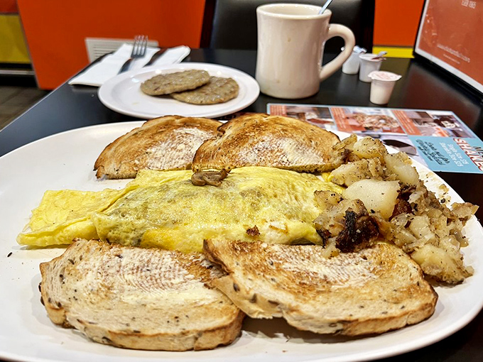 An omelet that's seen things. Folded around enough fillings to constitute a small farmers market, with toast standing by for support.