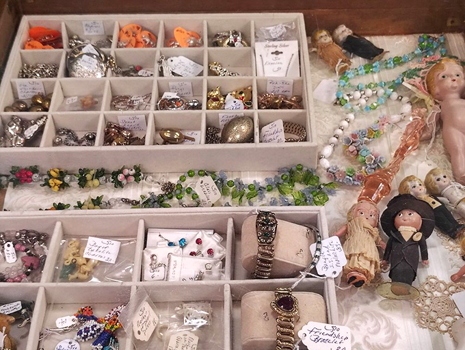 A collector's dream&mdash;tiny treasures organized in perfect compartments, where vintage jewelry and miniature dolls await their second chance at adoration.