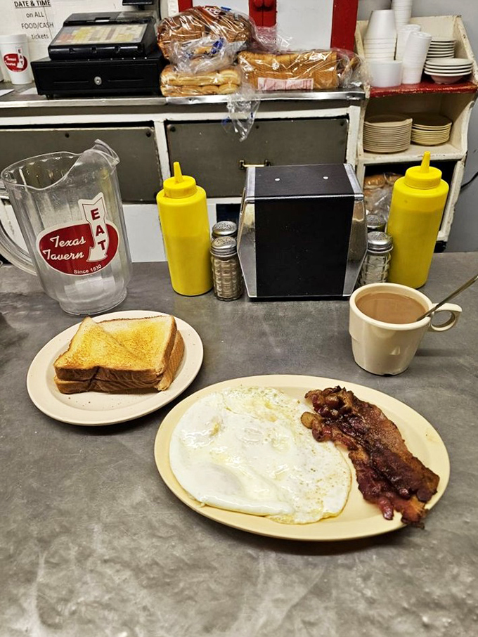 The breakfast trifecta: golden toast, bacon with the perfect crisp-to-chew ratio, and eggs sunny-side up&mdash;all awaiting their coffee companion.