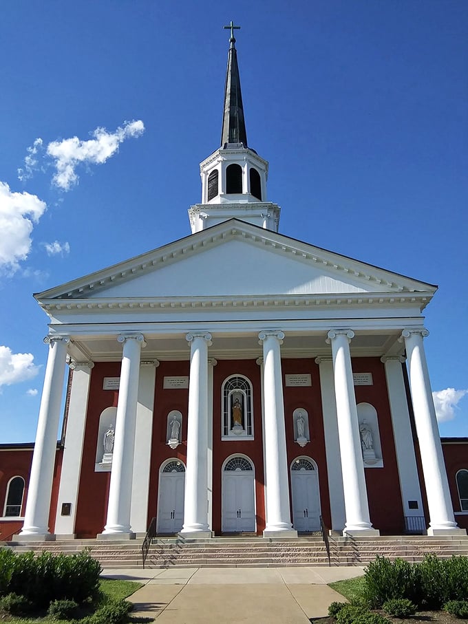 The Basilica of St. Joseph Proto-Cathedral stands majestically against the blue Kentucky sky, its classical columns reaching skyward like bourbon-inspired prayers.