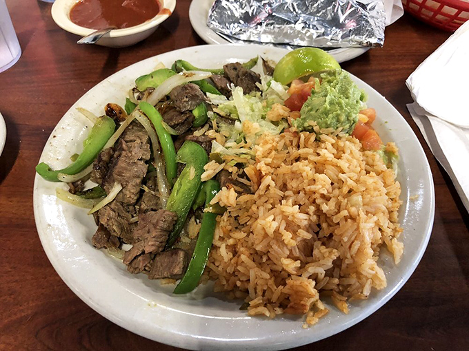 Sizzling beef fajitas share the plate with Spanish rice that's actually been introduced to flavor. The green peppers add both color and a sweet crunch.