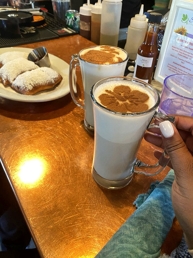 Powdered sugar-dusted beignets alongside chai lattes with leaf art. New Orleans and India had a delicious baby in Denver.