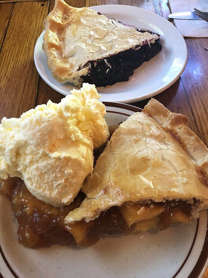 A trio of pies that should be in the Smithsonian. The flaky crust shatters with your fork like delicate glass, revealing fruit filling that tastes like summer memories.