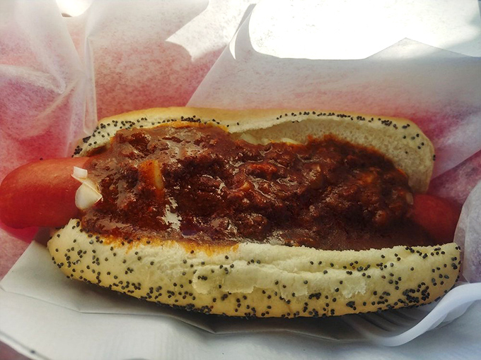 The chili doesn't hide the hot dog; it celebrates it. Each bite delivers that perfect balance of spice, meat, and pillowy bun.