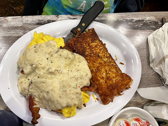 Biscuits swimming in country gravy with a side of hash browns&mdash;carb heaven that makes you simultaneously regret and celebrate your life choices.