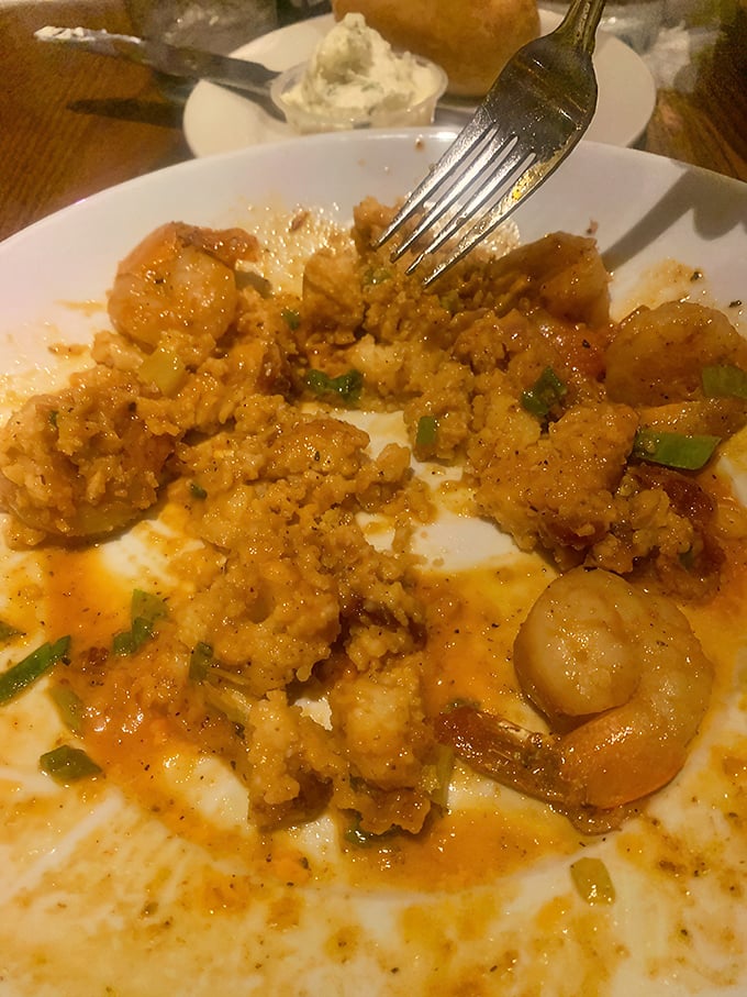 Cajun-spiced revelations arranged around that golden disk of cornmeal heaven. Whoever said "simple food" clearly never had grits this transformative.