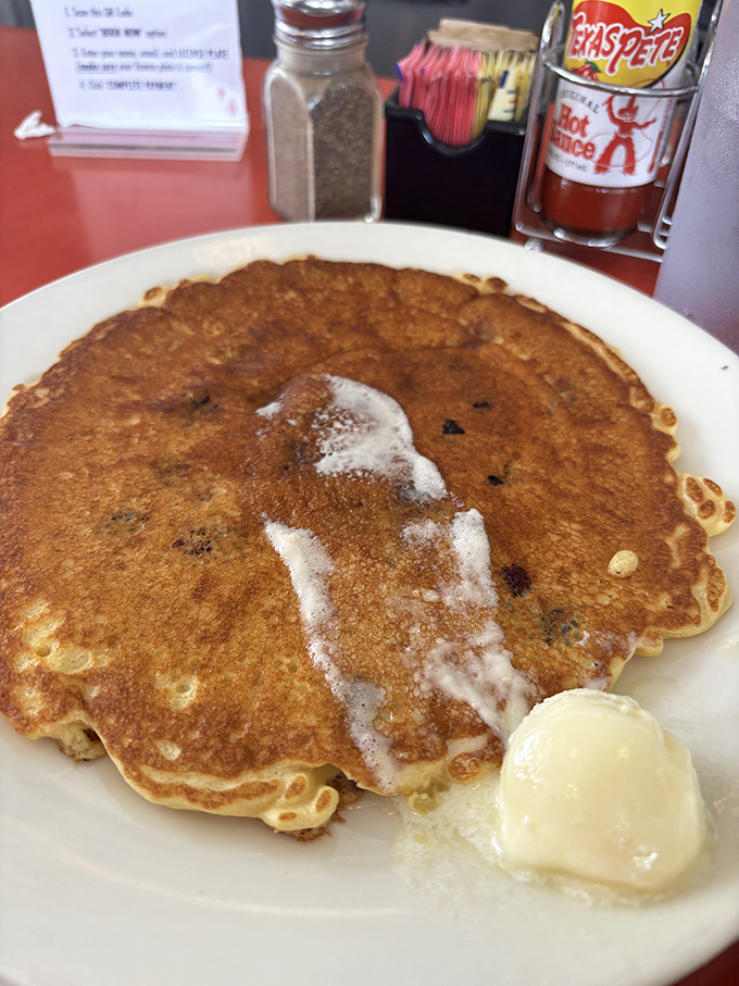 A pancake so perfectly golden it deserves its own spot on Atlanta's Walk of Fame, with butter slowly creating a delicious puddle.