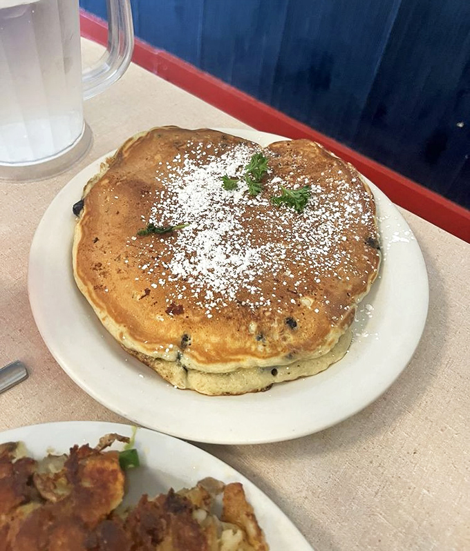 Blueberry pancakes dusted with powdered sugar&mdash;where "I'll just have a bite" becomes "I need a nap" in record time.