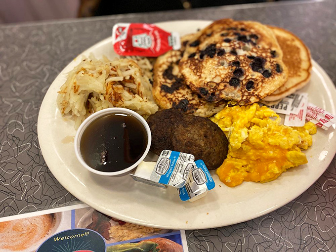 Blueberry pancakes that could make a maple tree weep with joy, paired with eggs that practically glow with morning sunshine.
