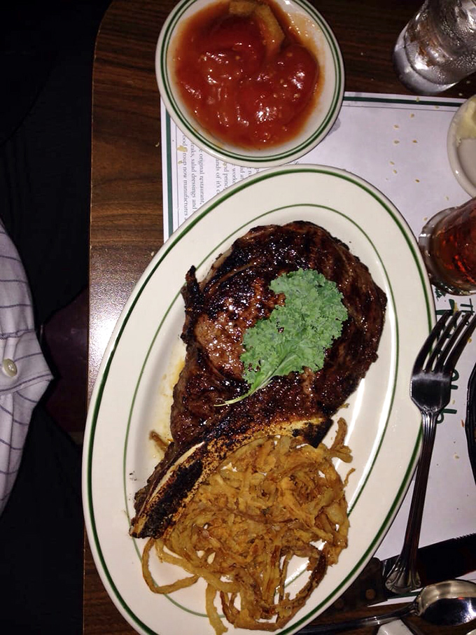 The bone-in ribeye arrives with a simple garnish, because when you're this good, you don't need to dress up.