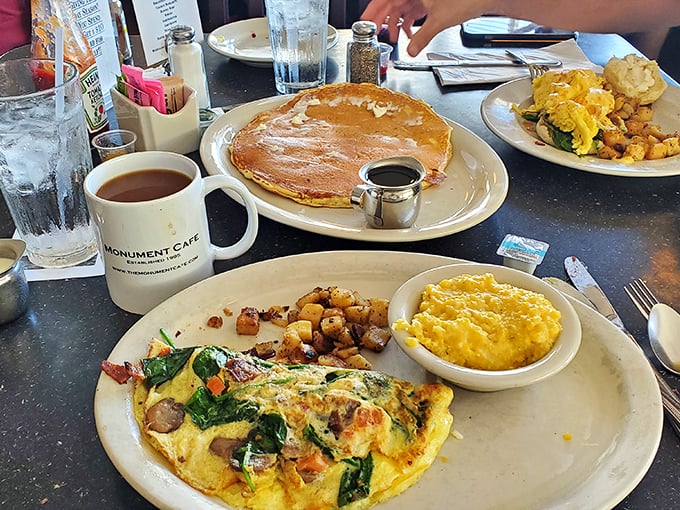 An omelet that's having a party and invited all your favorite ingredients. Those home fries look like they've been practicing for this moment.