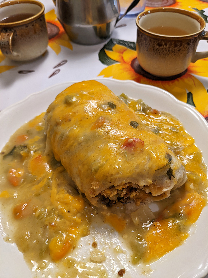 This breakfast burrito isn't just smothered&mdash;it's embraced by a cheese sauce that should win humanitarian awards for bringing joy to mornings.