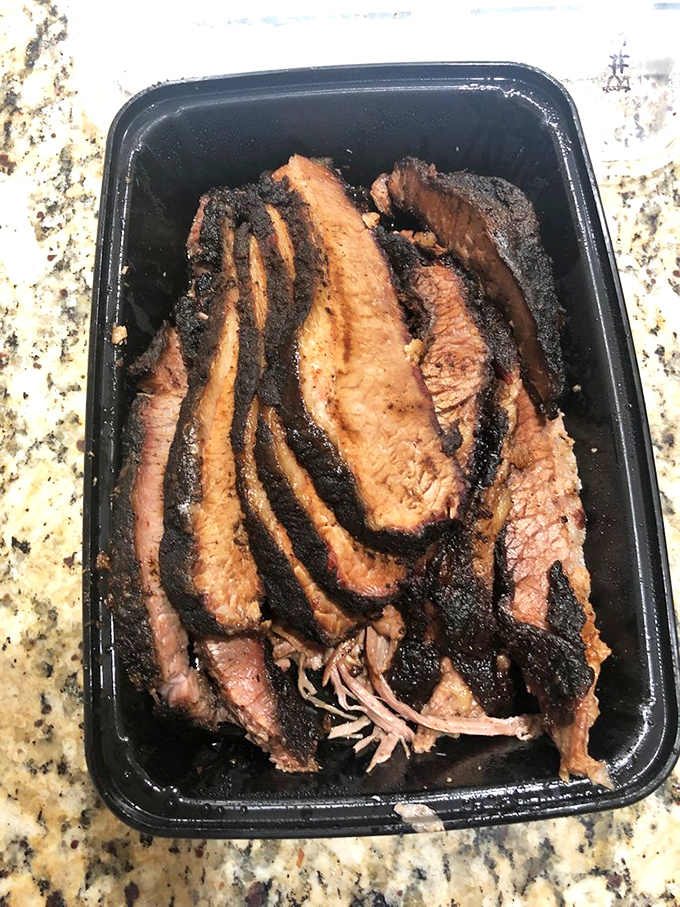 Brisket with a smoke ring so perfect it could make a Texan weep. The bark-to-meat ratio here is what BBQ dreams are made of.