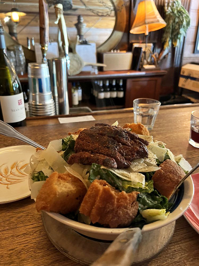 Caesar salad gets promoted from supporting player to co-star when paired with oak-grilled steak and those glorious homemade croutons.