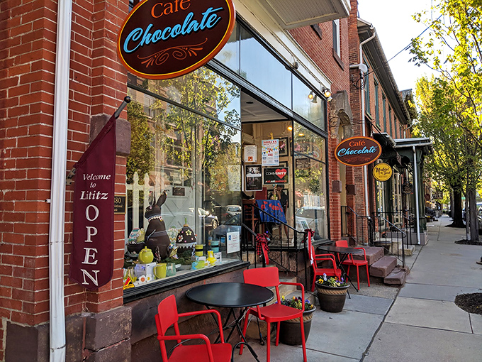 Caf&eacute; Chocolate's inviting storefront promises sweet salvation for weary shoppers, with those red chairs practically shouting "Coffee break!" to passersby.