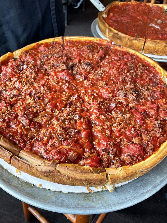 This isn't just a pizza&mdash;it's a structural marvel. The golden crust contains a treasure trove of toppings beneath that signature tomato blanket.