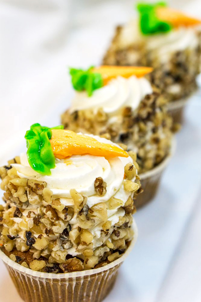 These carrot cupcakes stand at attention like tiny soldiers in the war against boring desserts, each one crowned with a perfect carrot.