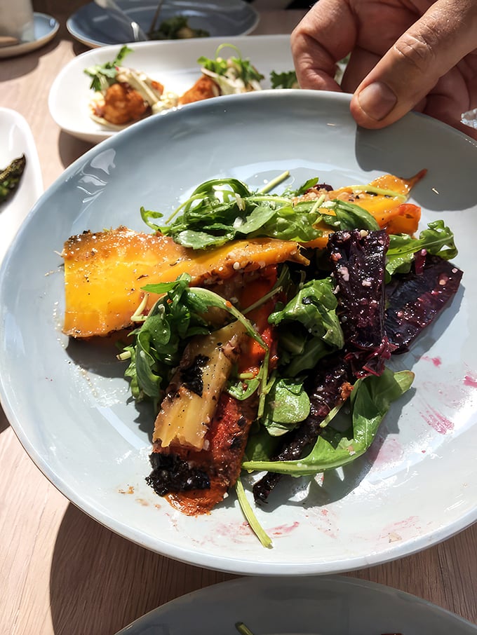 A symphony of colors and textures&mdash;roasted carrots and fresh greens playing off each other like old friends reuniting after too long apart.