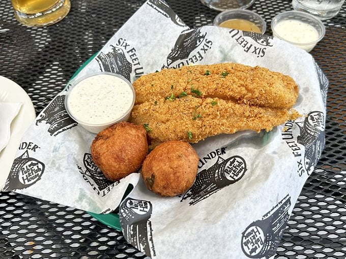 Southern comfort on a plate. These golden catfish fillets and hush puppies are what deep-fry dreams are made of.