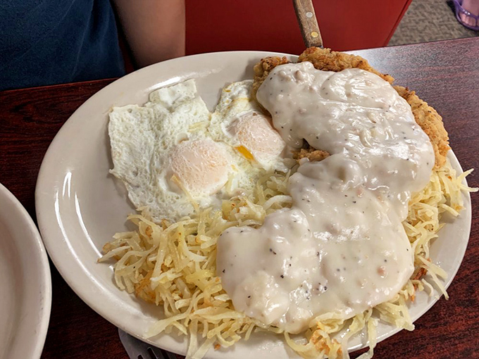 Chicken fried steak smothered in country gravy atop hash browns &ndash; a dish so comforting it should come with a pillow and blanket.
