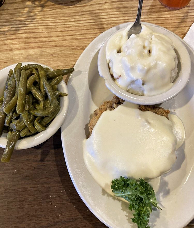 Chicken fried steak smothered in gravy so good you'll want to write it love letters. Southern comfort on a plate.