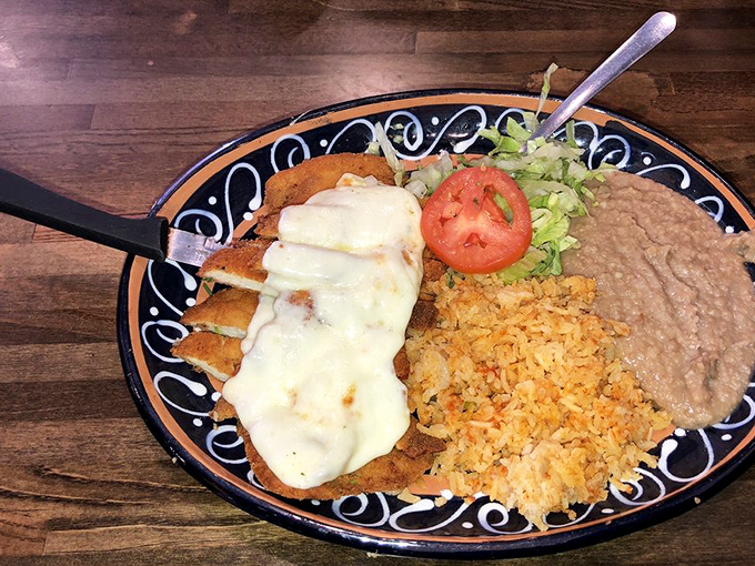 The Milanesa's golden-brown perfection sits proudly on a traditional plate, proving that sometimes the simplest dishes require the most skill to execute flawlessly.
