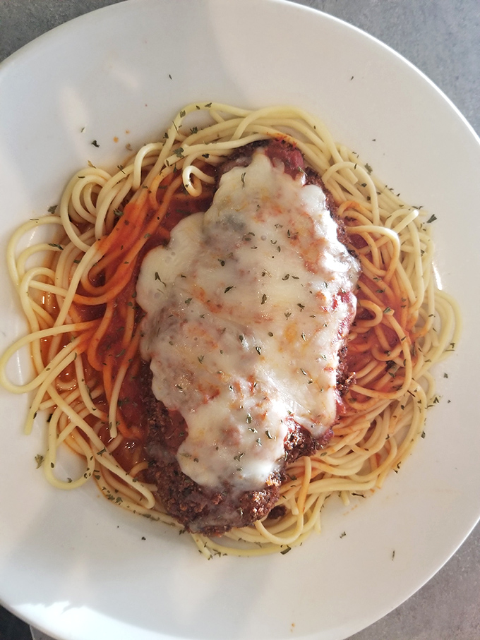 Their chicken parmesan doesn't need a fancy Italian accent – it speaks the universal language of melted cheese and marinara.
