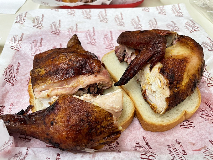 This sandwich isn't just food; it's architectural achievement. Two slices of white bread valiantly attempting to contain a skyscraper of smoky chicken.