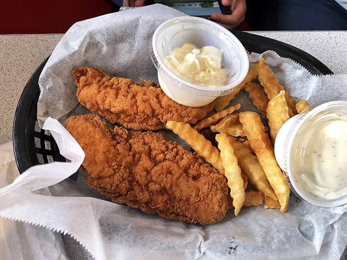 Golden-fried chicken tenders with a side of crispy fries &ndash; comfort food that speaks the universal language of "everything's gonna be alright."