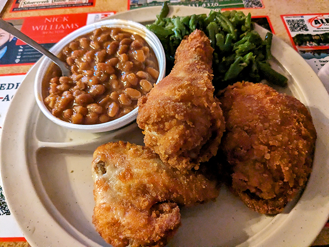 The supporting cast deserves applause too: green beans and baked beans flanking the star of the show &ndash; that gloriously golden chicken.