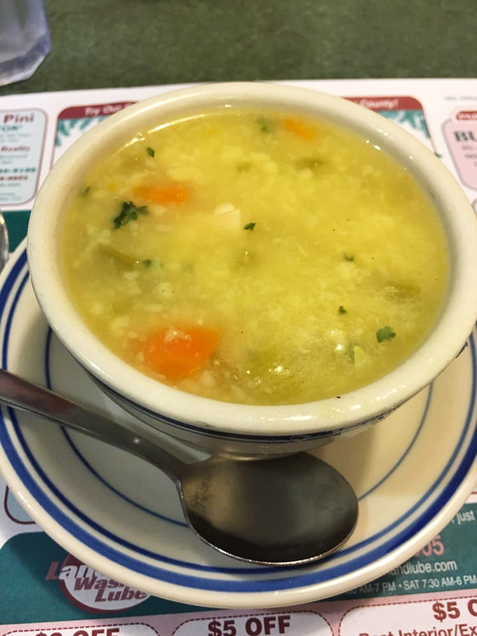 A bowl of chicken corn soup that looks like liquid comfort. The kind of soup your grandmother would approve of&mdash;clear broth, visible vegetables, and no pretentious garnishes.