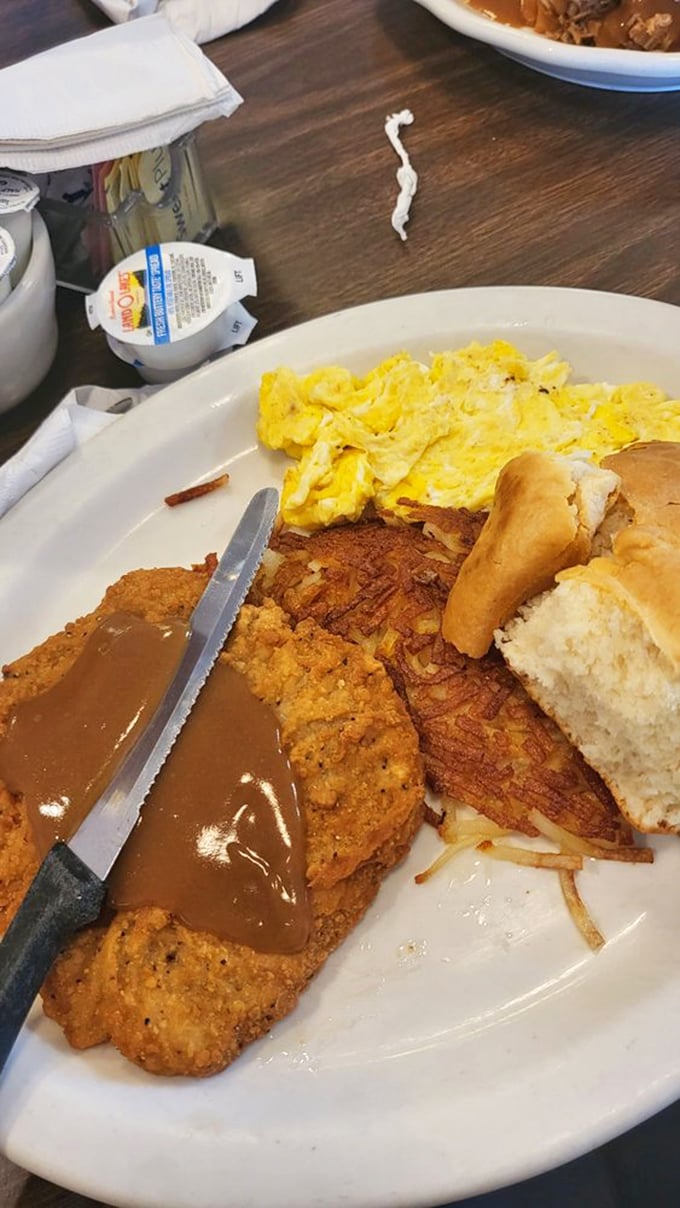 Breakfast of champions: golden chicken fried steak under country gravy, eggs sunny-side up, and a biscuit that didn't come from any tube. Morning glory, indeed.