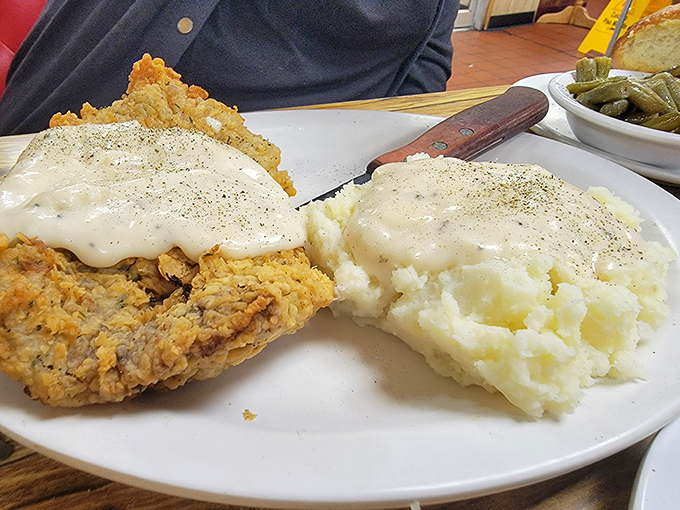Chicken fried steak smothered in country gravy&mdash;the kind of dish that makes you forget about cholesterol and remember what comfort tastes like.